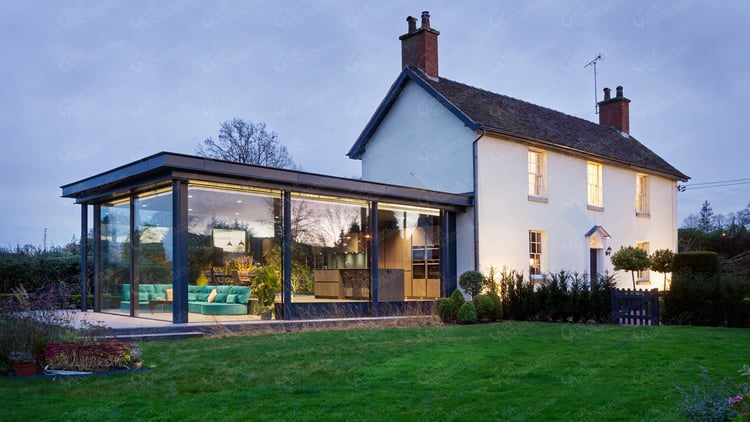A contemporary glazed extension to a Grade II Listed cottage